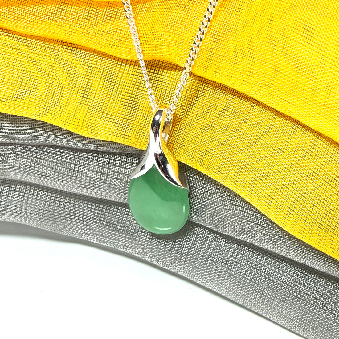 A gorgeous real green jade pendant in a teardrop or pear shape, a real ...