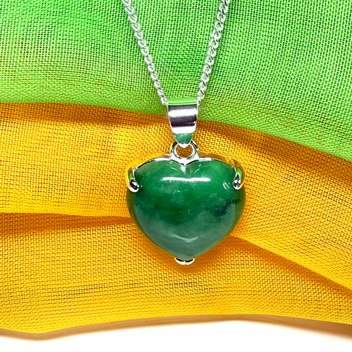 A real green jade pendant heart shaped sterling silver, a traditional ...