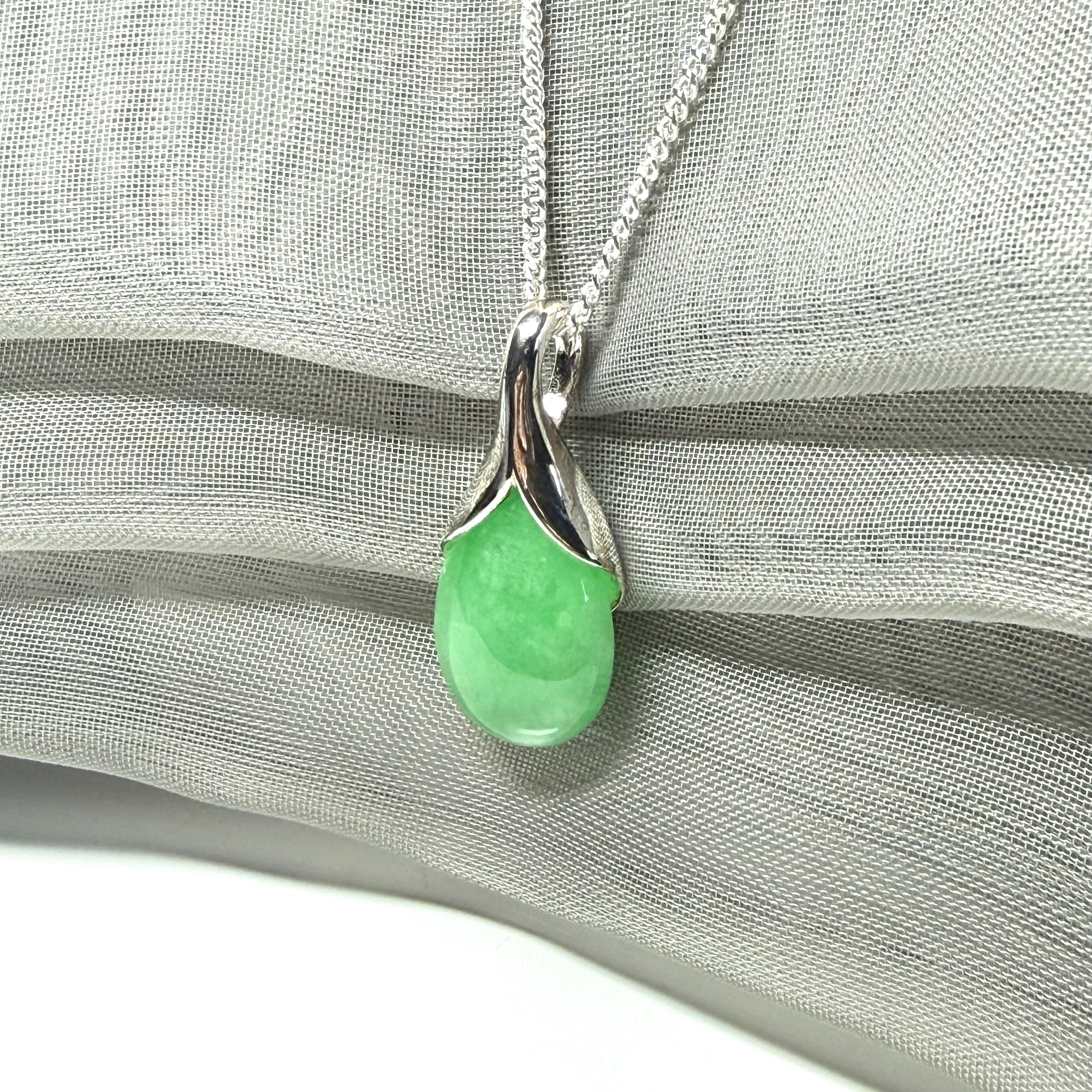 A real green jade necklace in a teardrop or a pear shape with a solid ...
