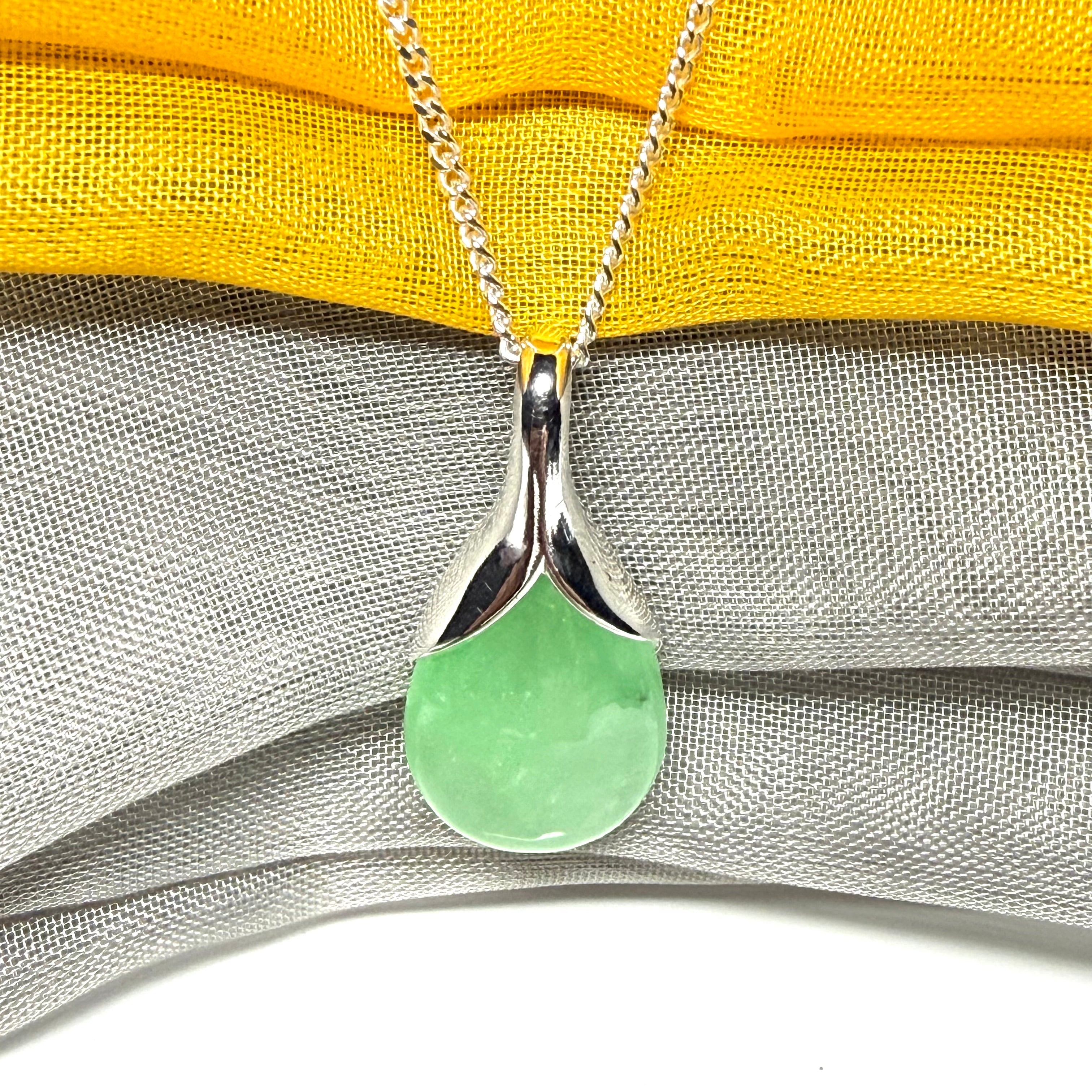 A real green jade necklace in a teardrop or pear shape, a traditional ...