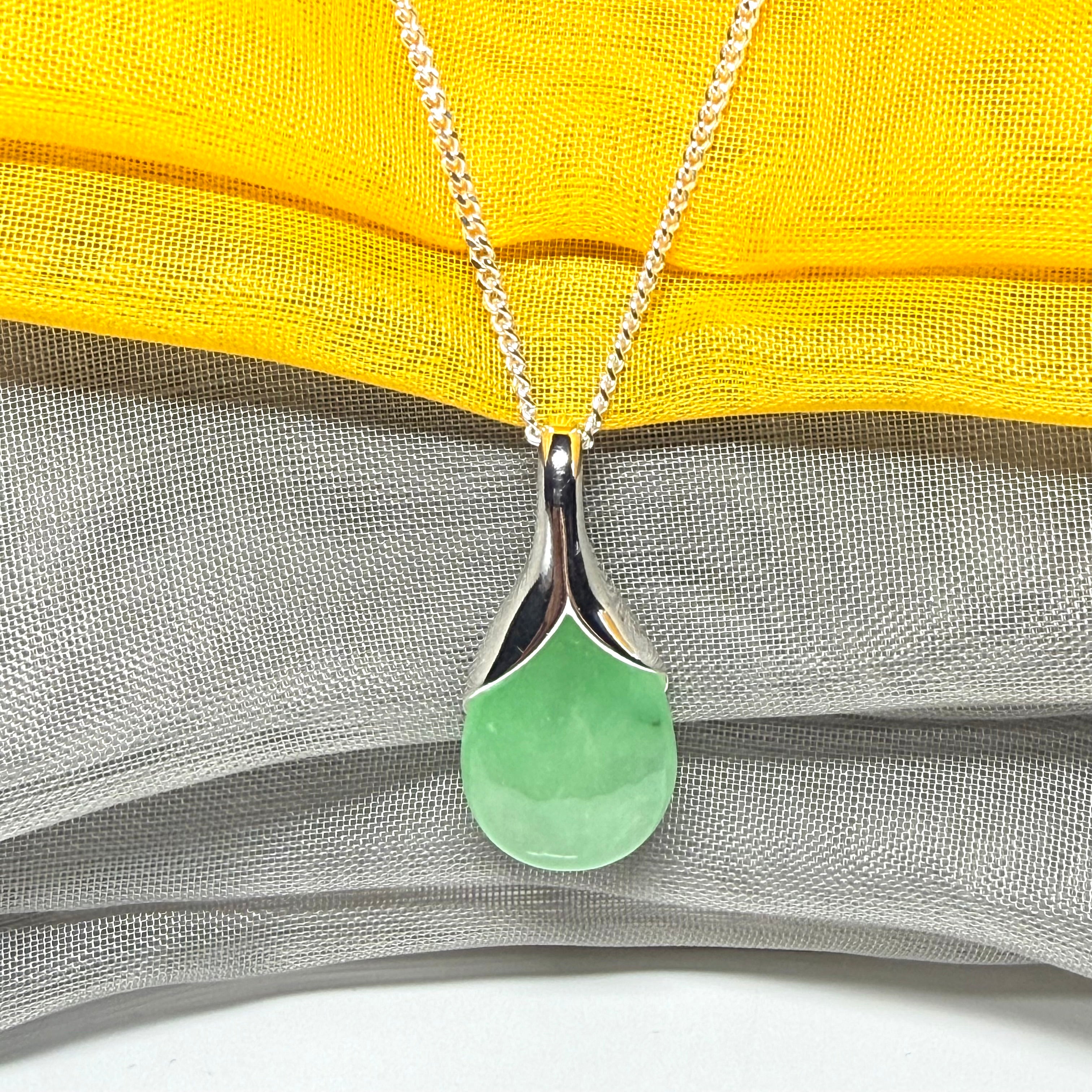 A real green jade necklace in a teardrop or pear shape, a traditional ...