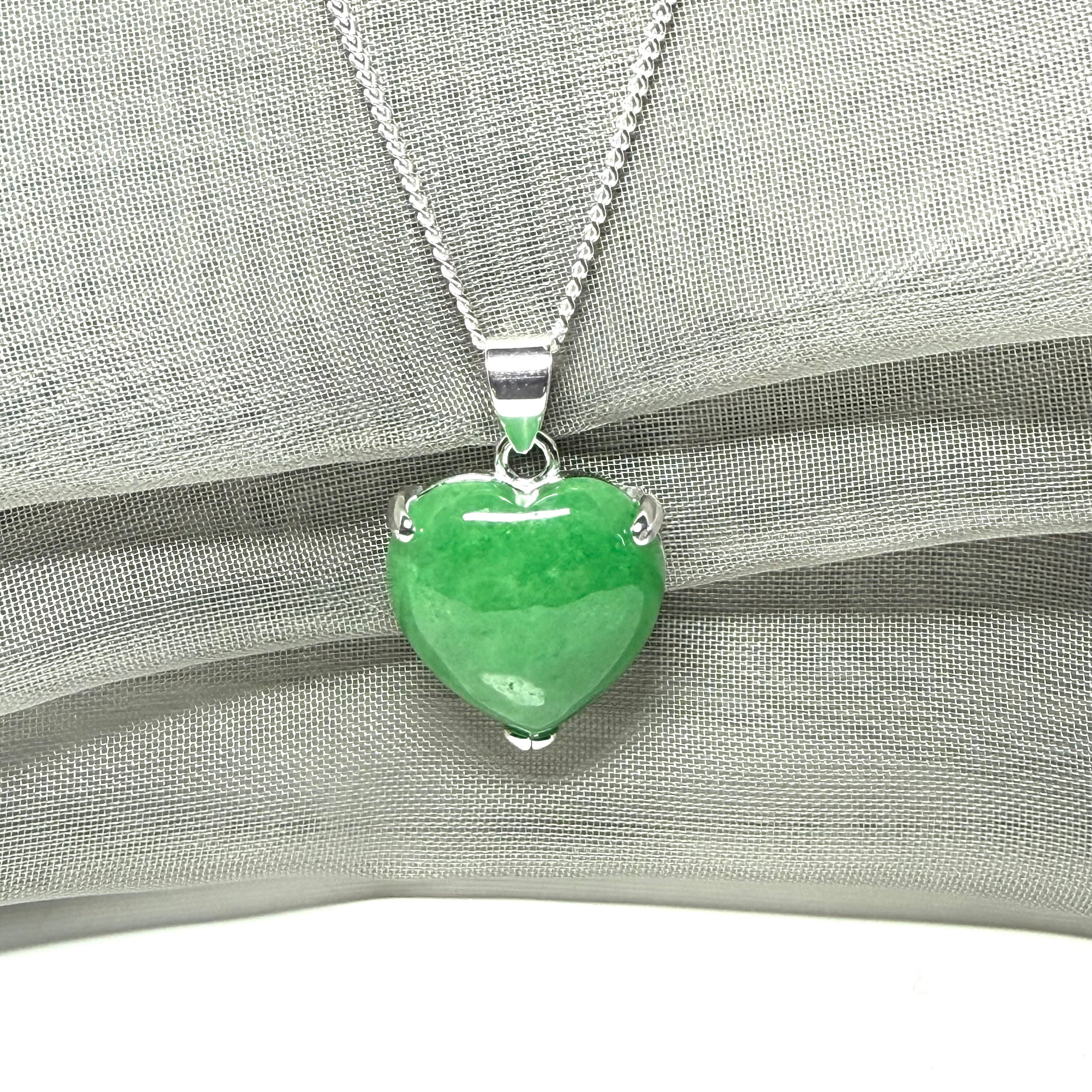A real green jade pendant heart shape sterling silver necklace with a ...