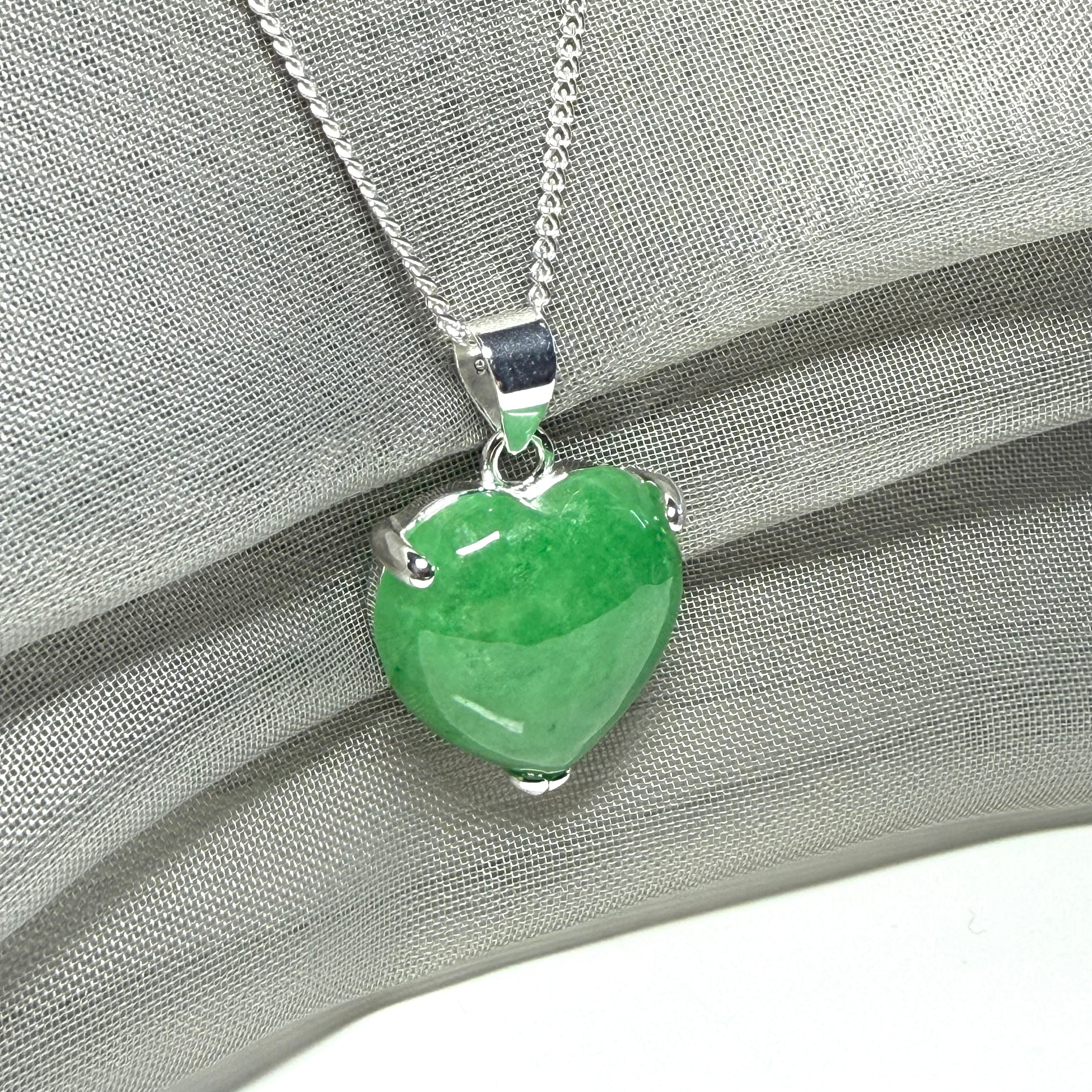 A real green jade pendant heart shape sterling silver necklace with a ...