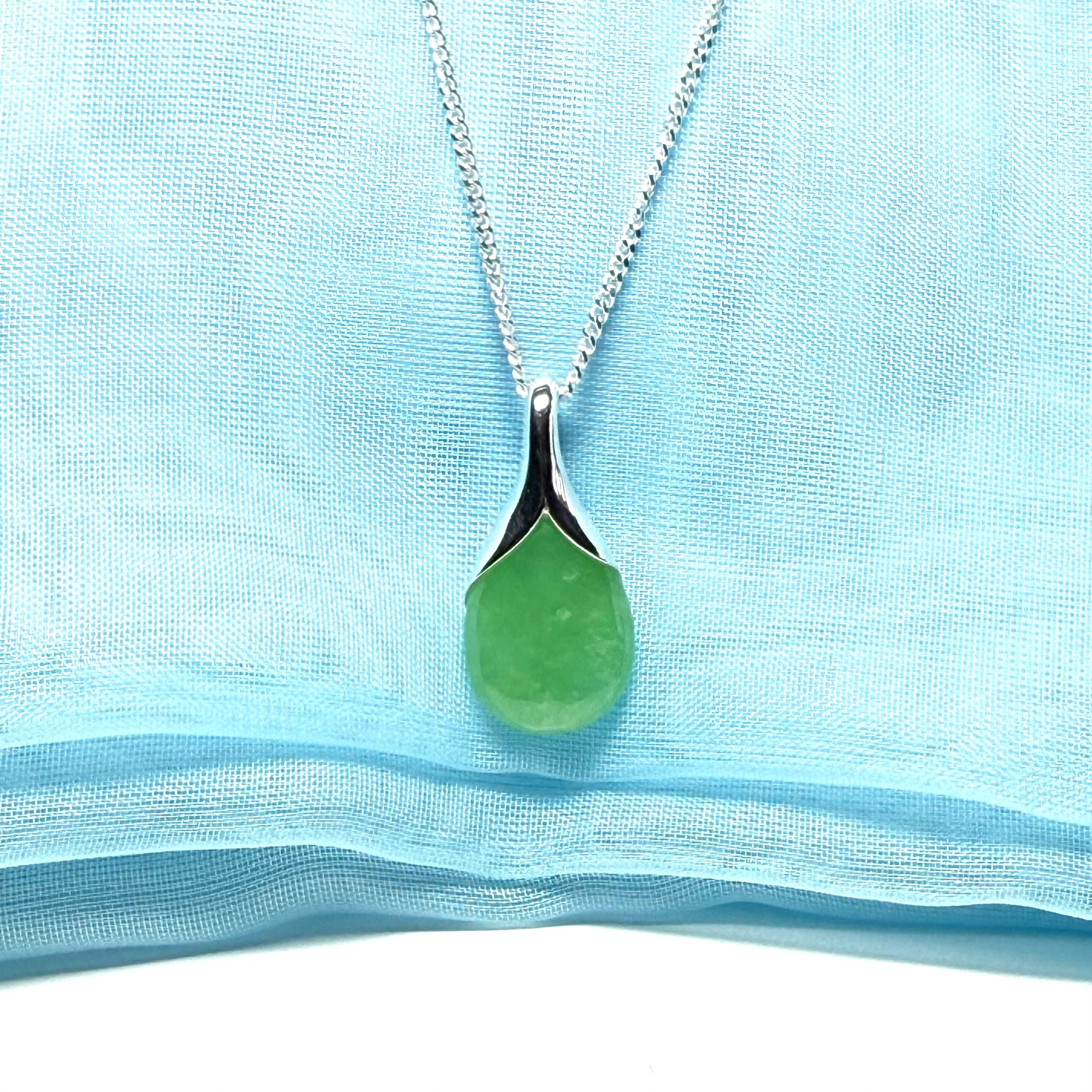 A real jade pendant in a teardrop shape or pear shaped designed green ...