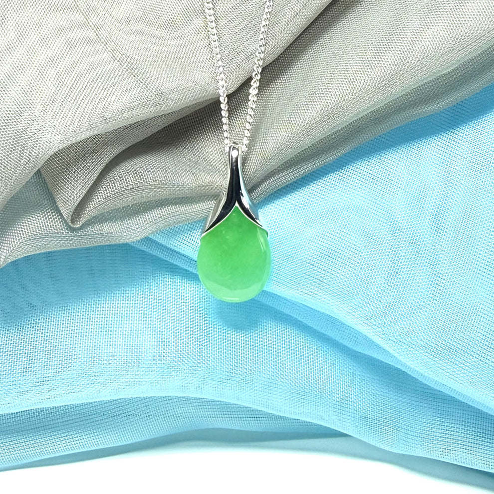 A real jade pendant in a teardrop shape or pear shaped designed green ...