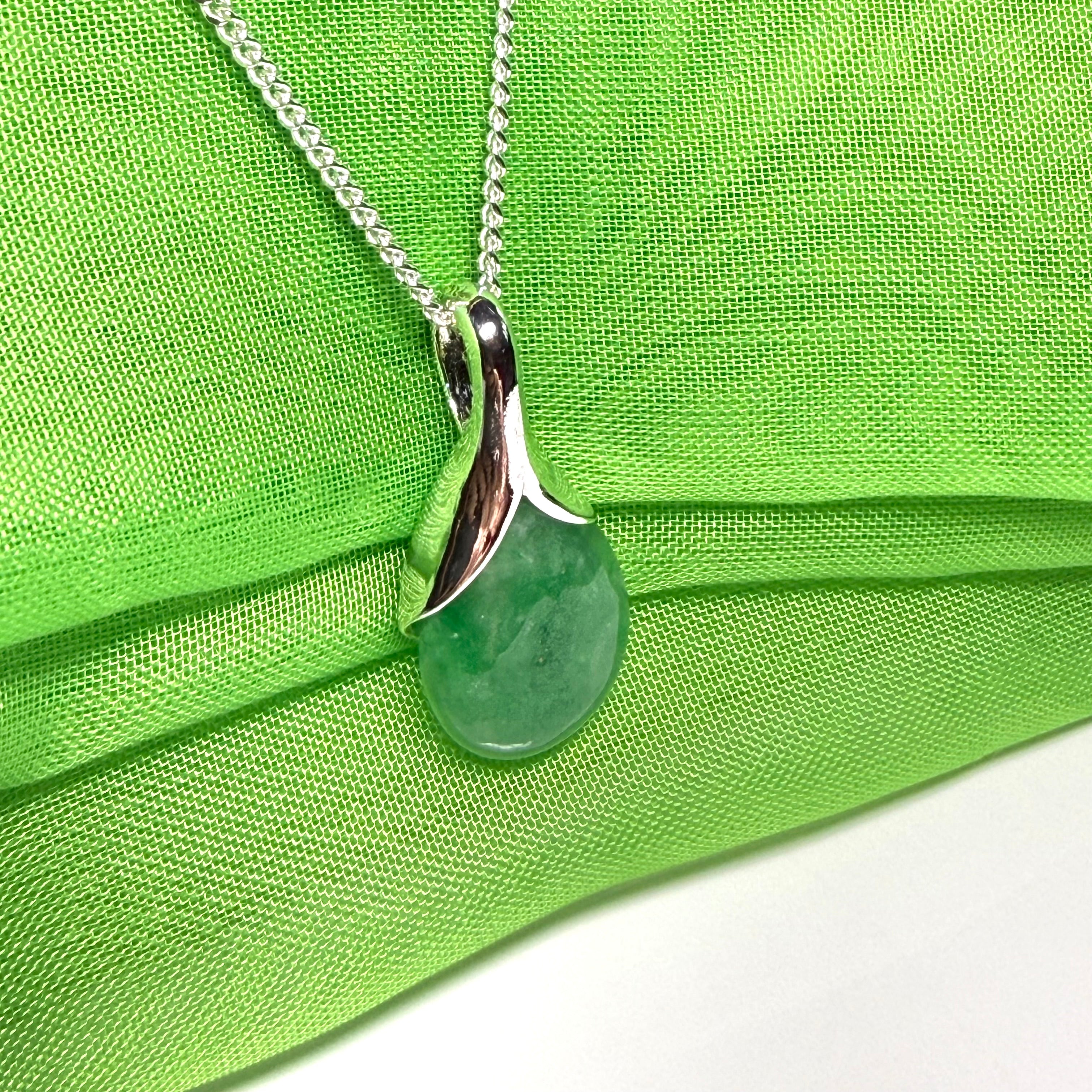 A real green jade necklace in a teardrop or pear shape, a traditional ...