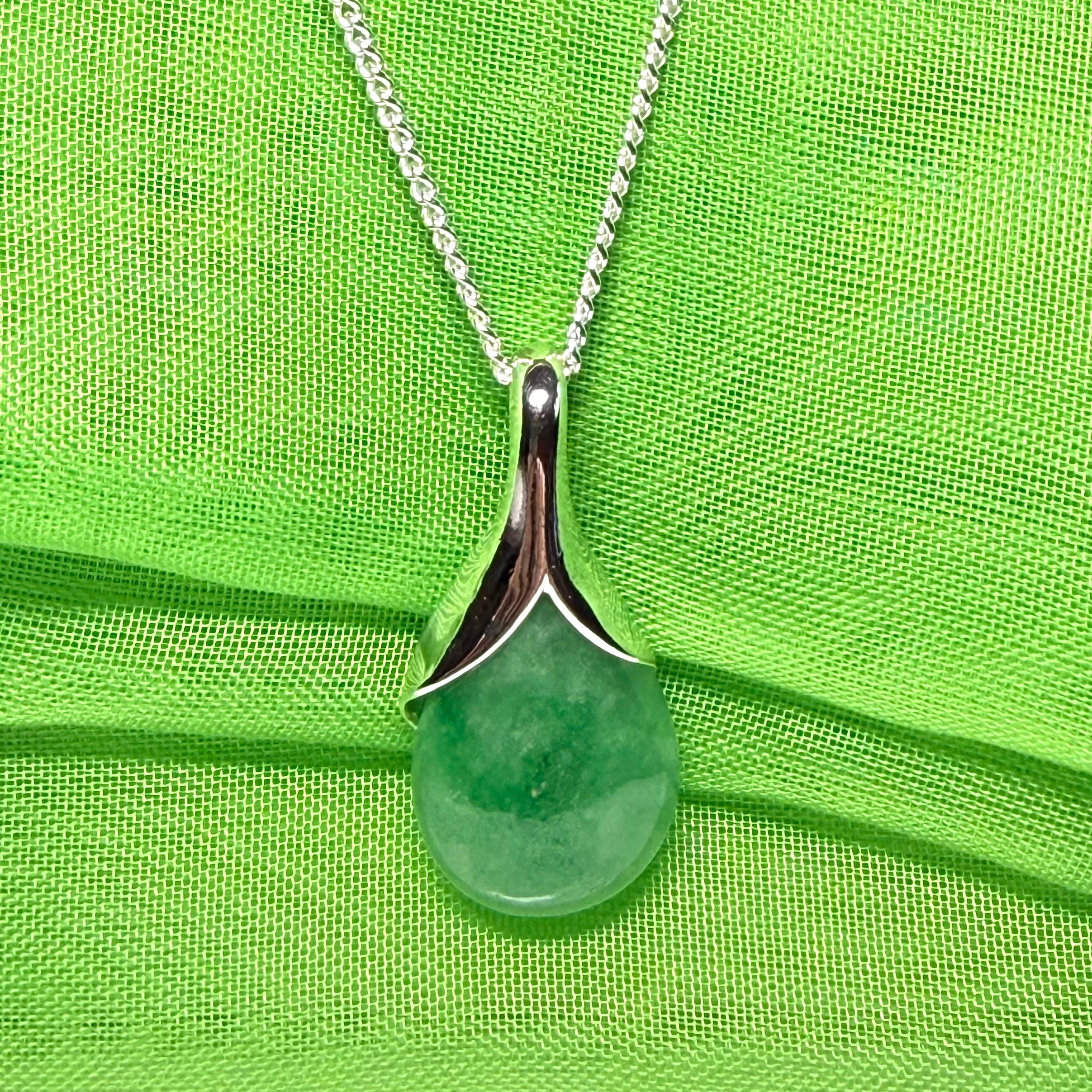 A real green jade necklace in a teardrop or pear shape, a traditional ...