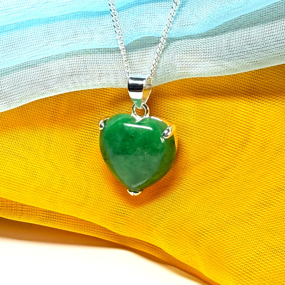A real green jade pendant heart shaped sterling silver, a traditional ...