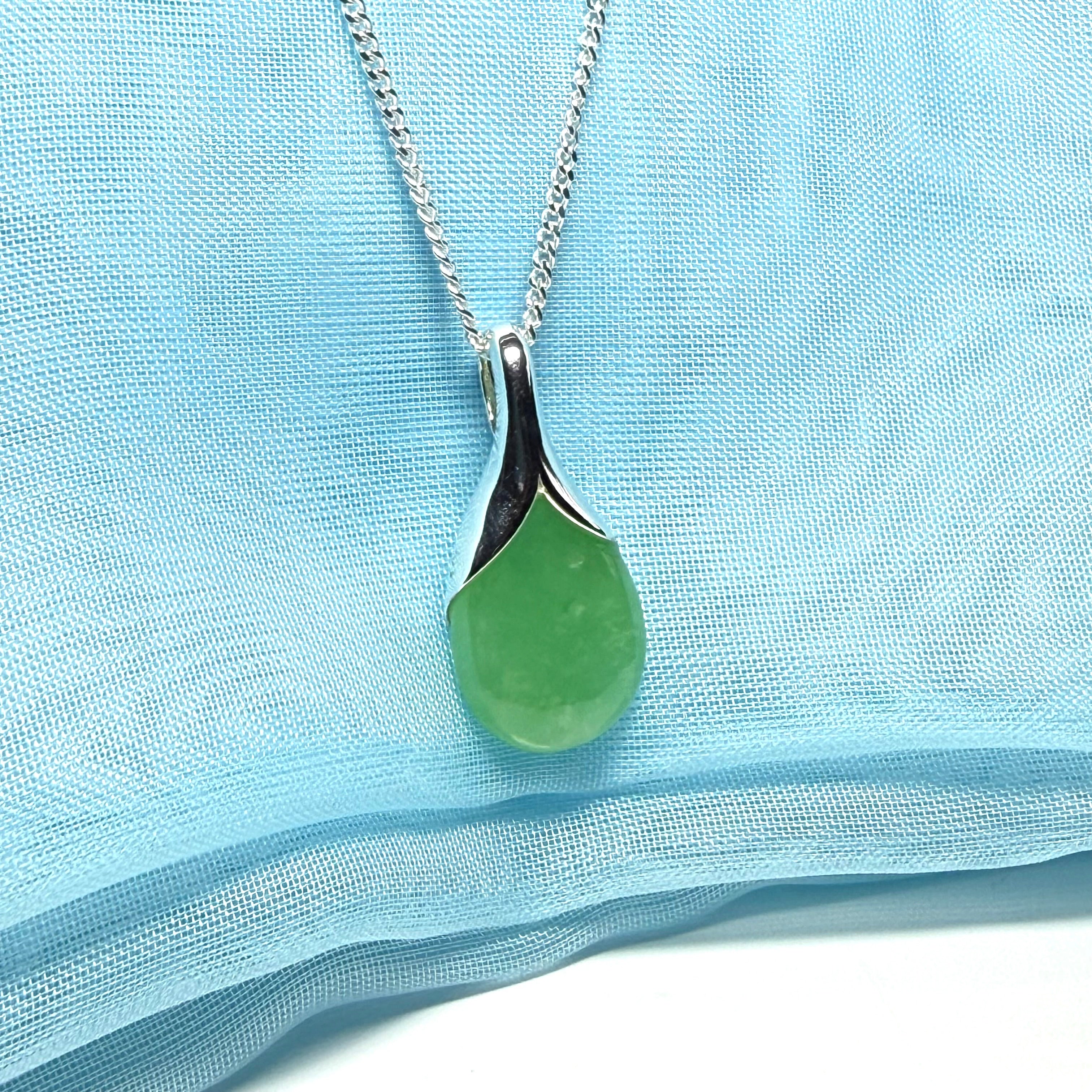 A real jade pendant in a teardrop shape or pear shaped designed green ...